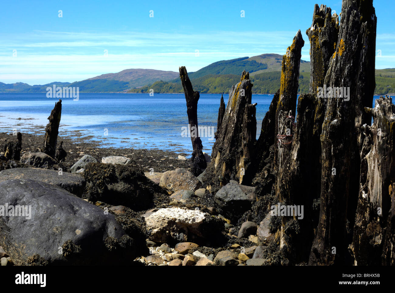 View across Loch Fyne from Strachur Bay. Derelict wooden pier in ...