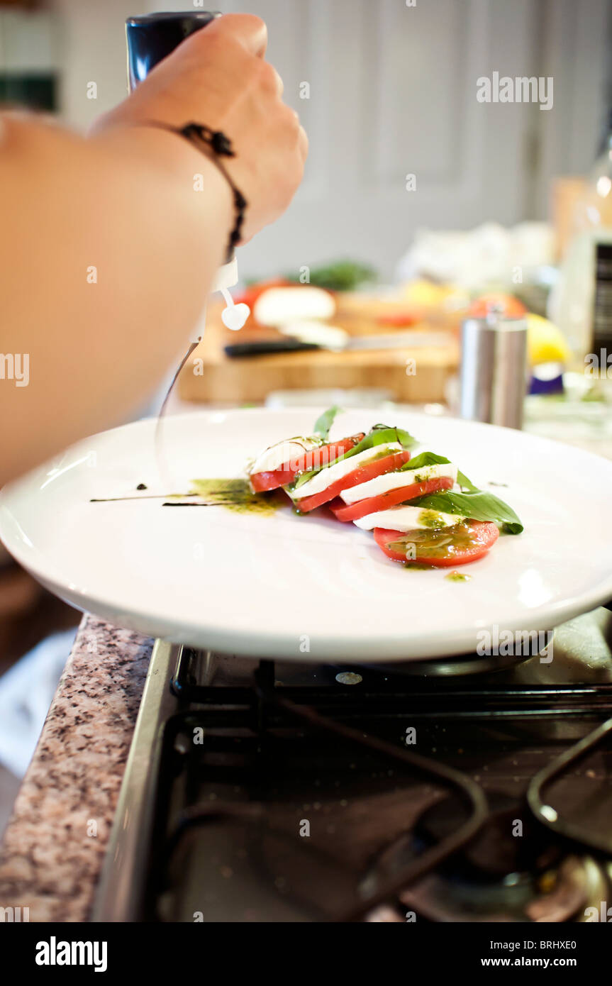 Posh salad with dressing being applied Stock Photo - Alamy