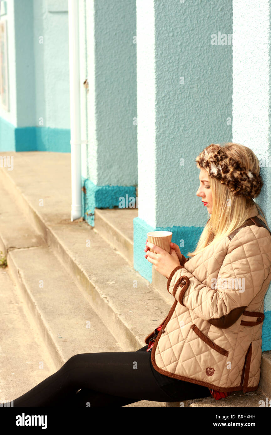 Young Woman Sitting Down Drinking Tea. Model Released Stock Photo - Alamy