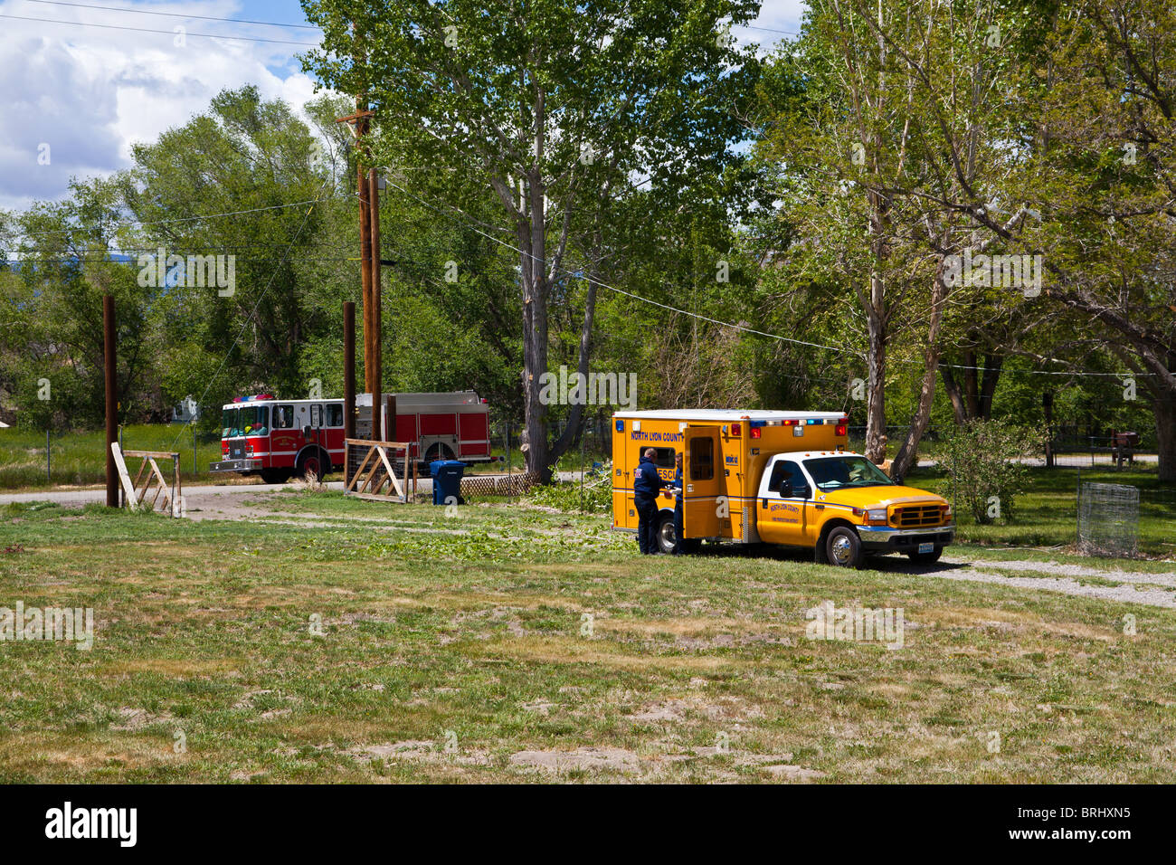 A rural fire departments paramedics treating a man injured by a falling ...