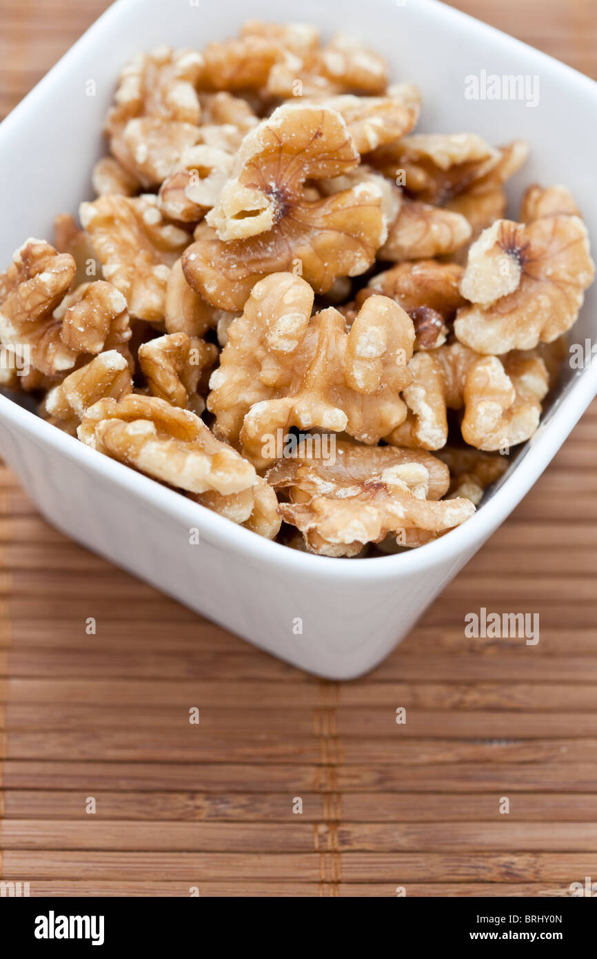 Shelled walnuts in a white dish Stock Photo - Alamy