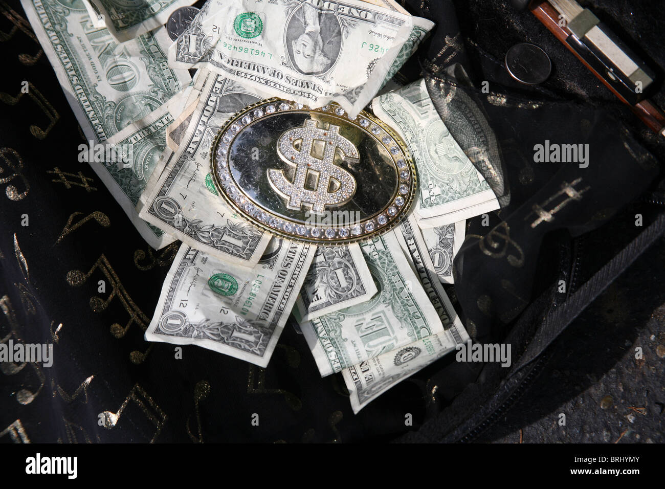 Money in street performer's guitar case Stock Photo - Alamy