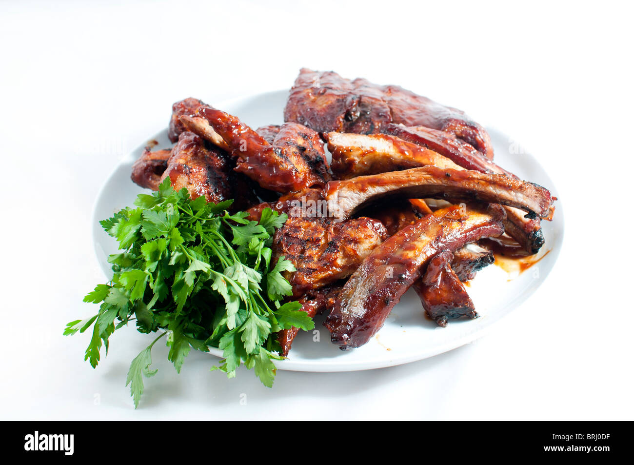 A plate of BBQ meat isolated on white Stock Photo - Alamy