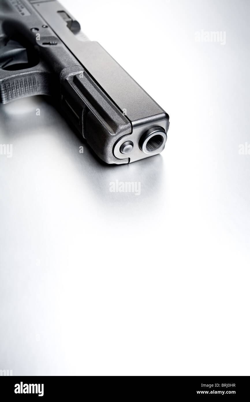 gun on highkey brushed metal background. closeup, focus on front Stock ...