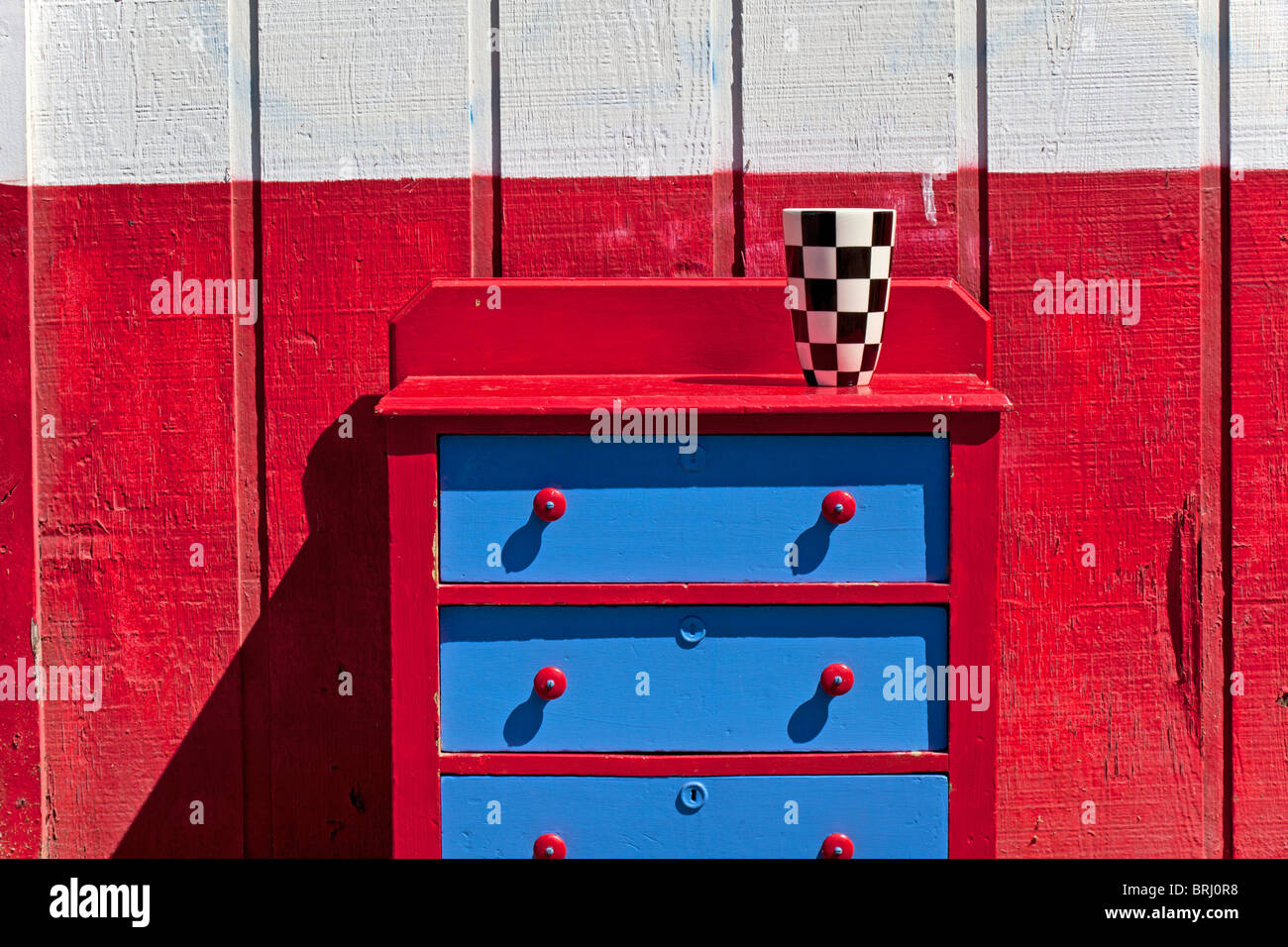 Checker vase on red drawers Stock Photo - Alamy