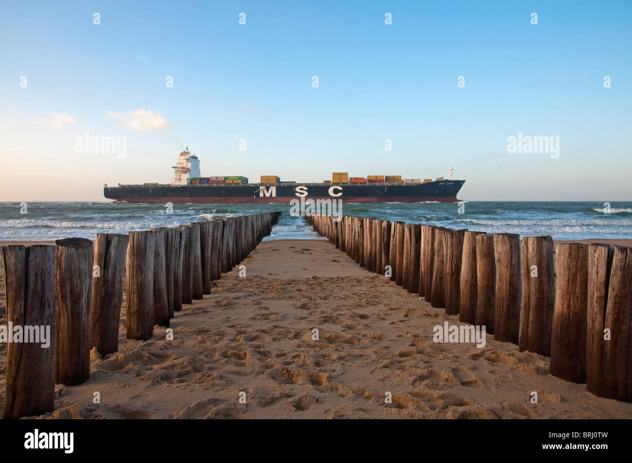 Container ship of the Mediterranean Shipping Line passes wooden ...