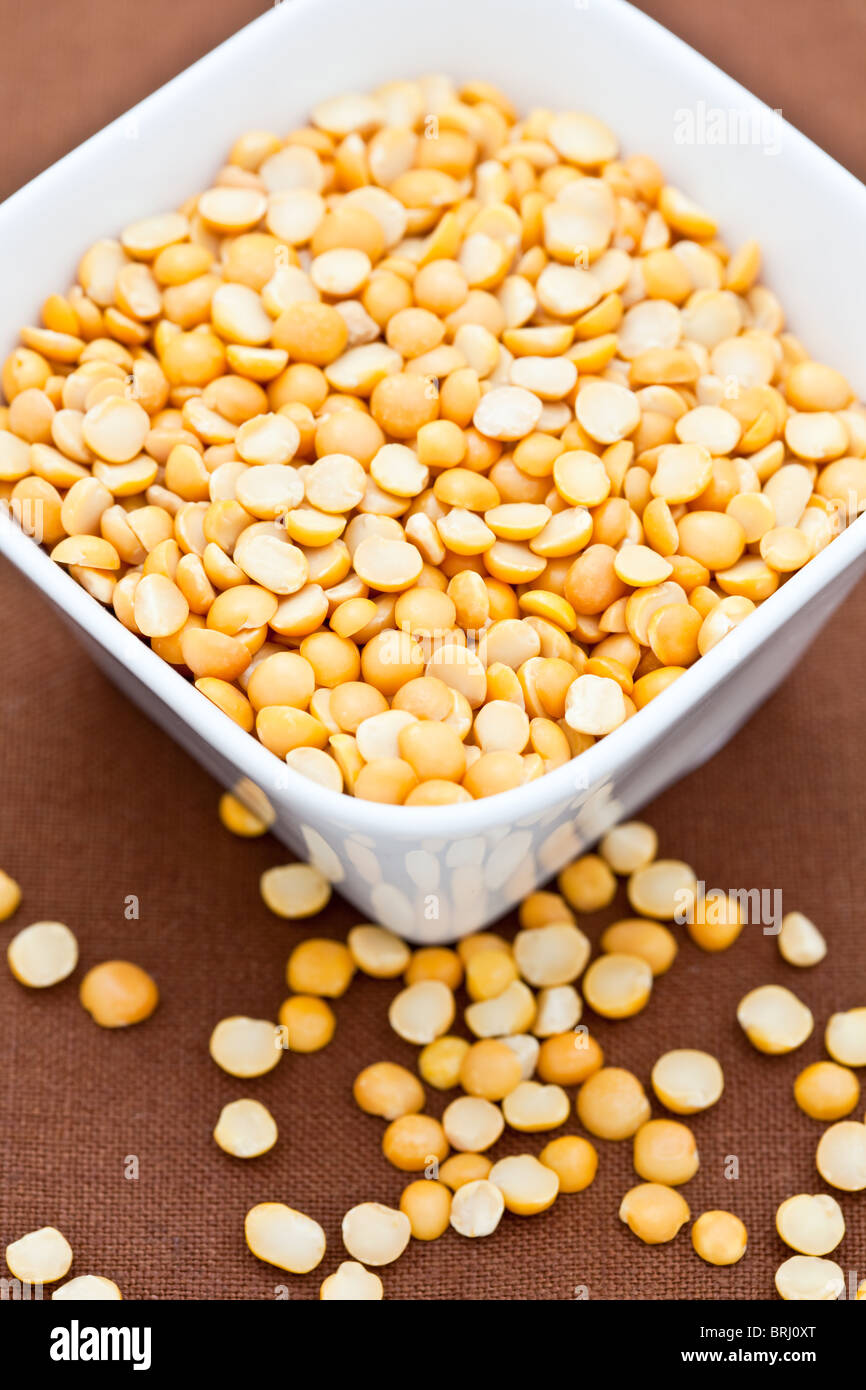Yellow split peas in a white bowl Stock Photo - Alamy