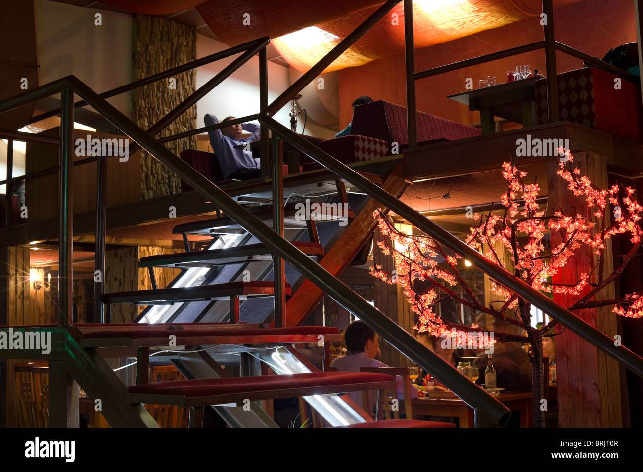two level restaurant interior with staircase and tree lamp Stock Photo ...