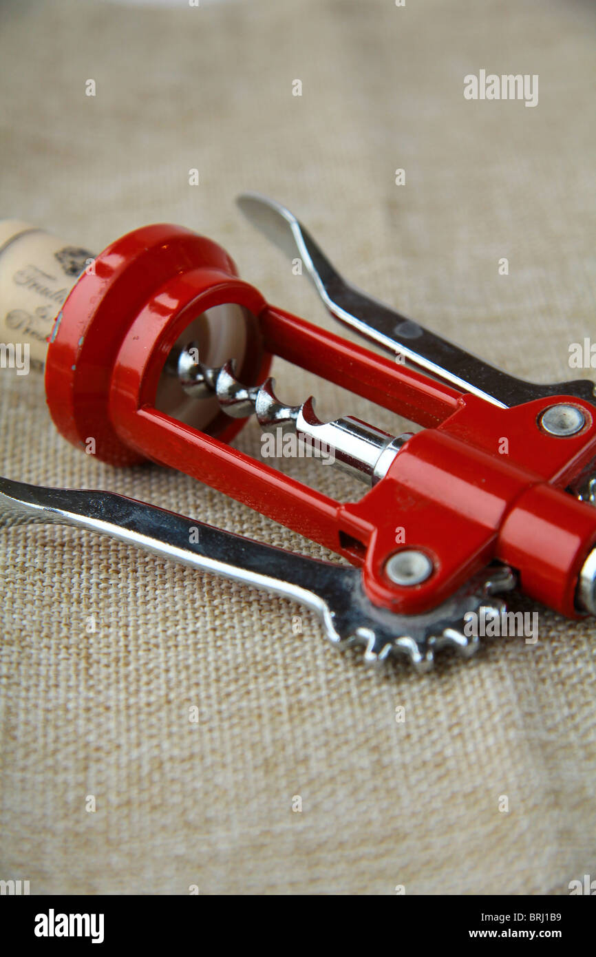 Red metallic corkscrew with a gray background Stock Photo - Alamy