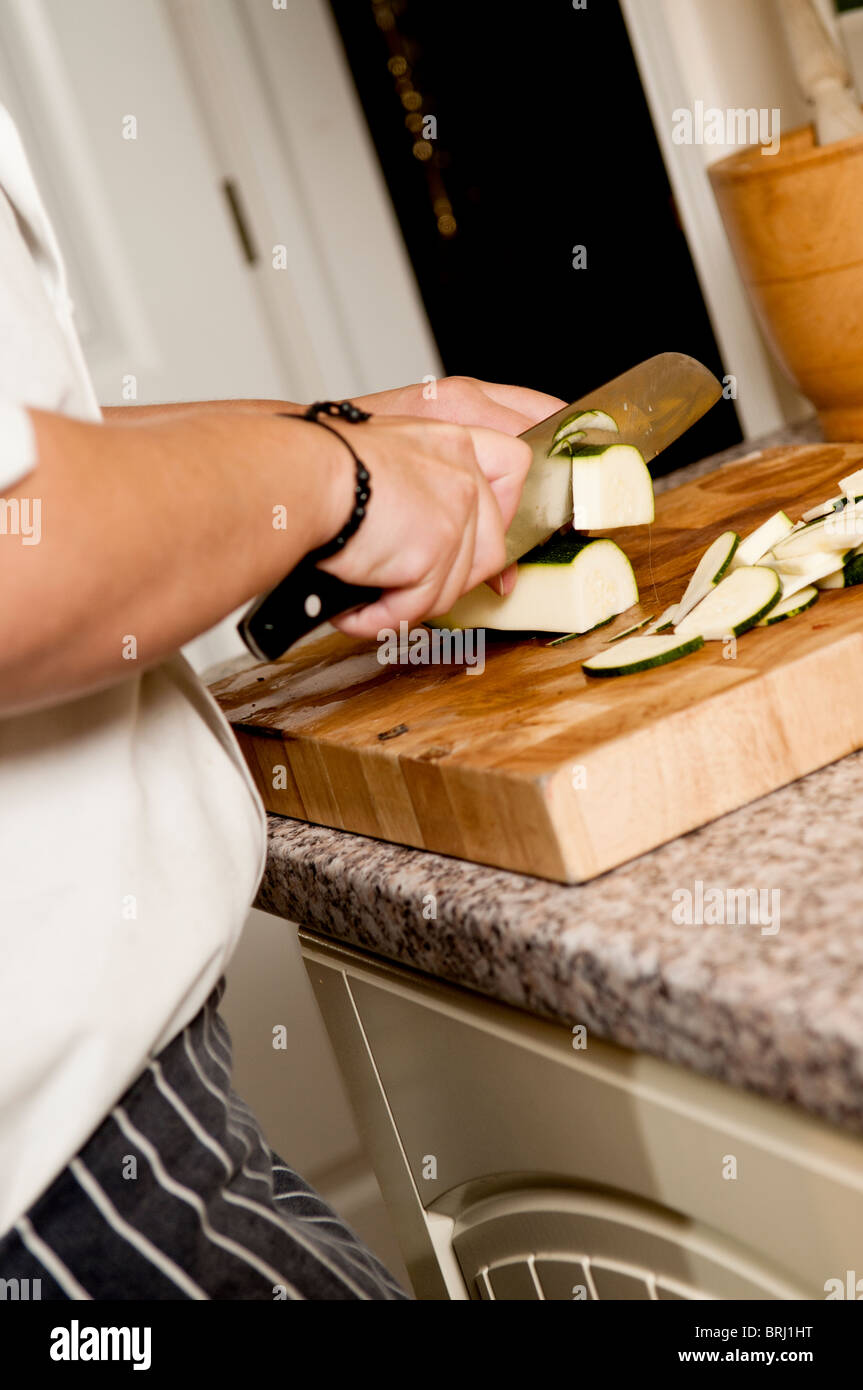 woman chef chopping vegetables on chopping board in kitchen Stock Photo ...