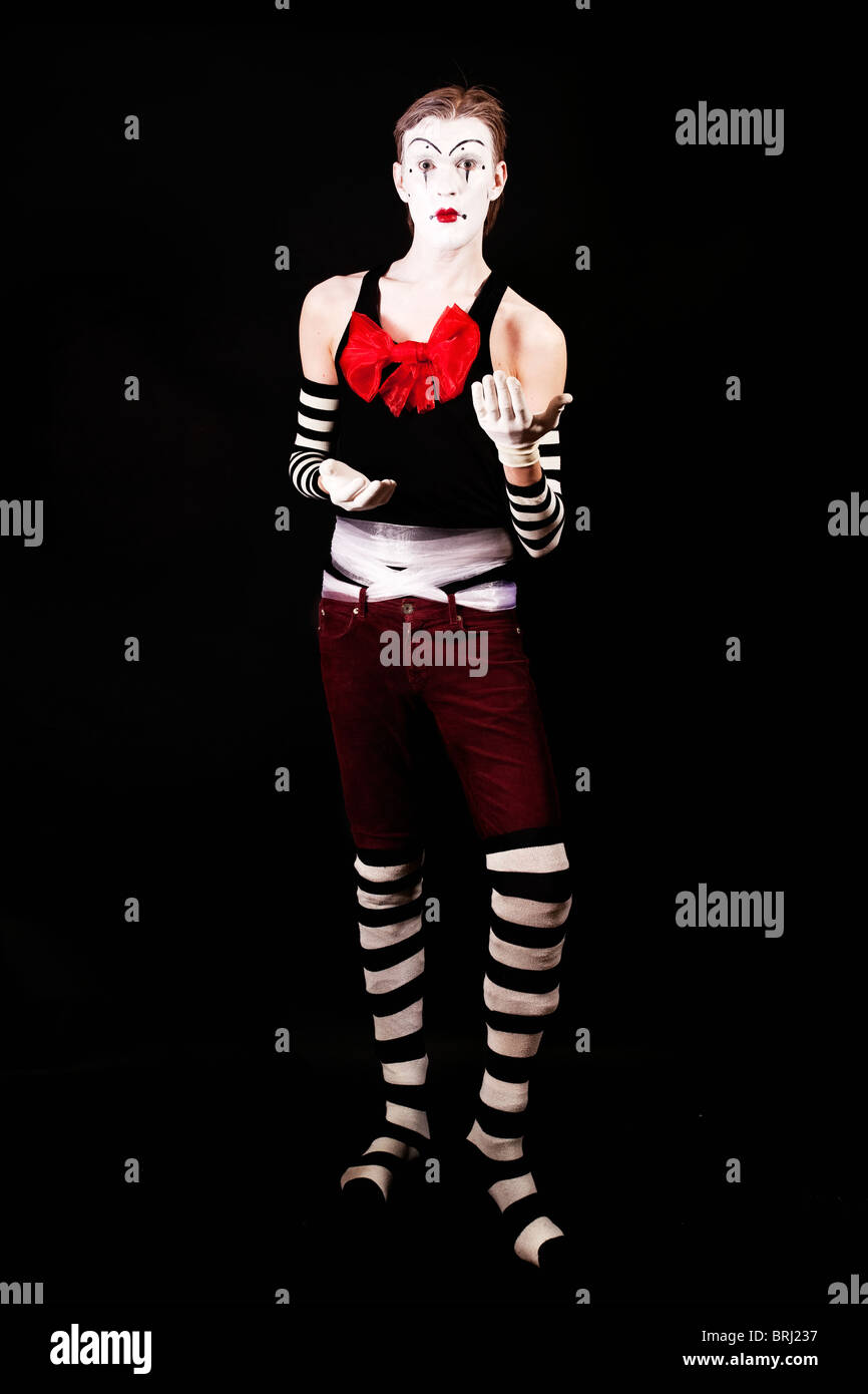 Mime with a big red bow on a black background Stock Photo - Alamy