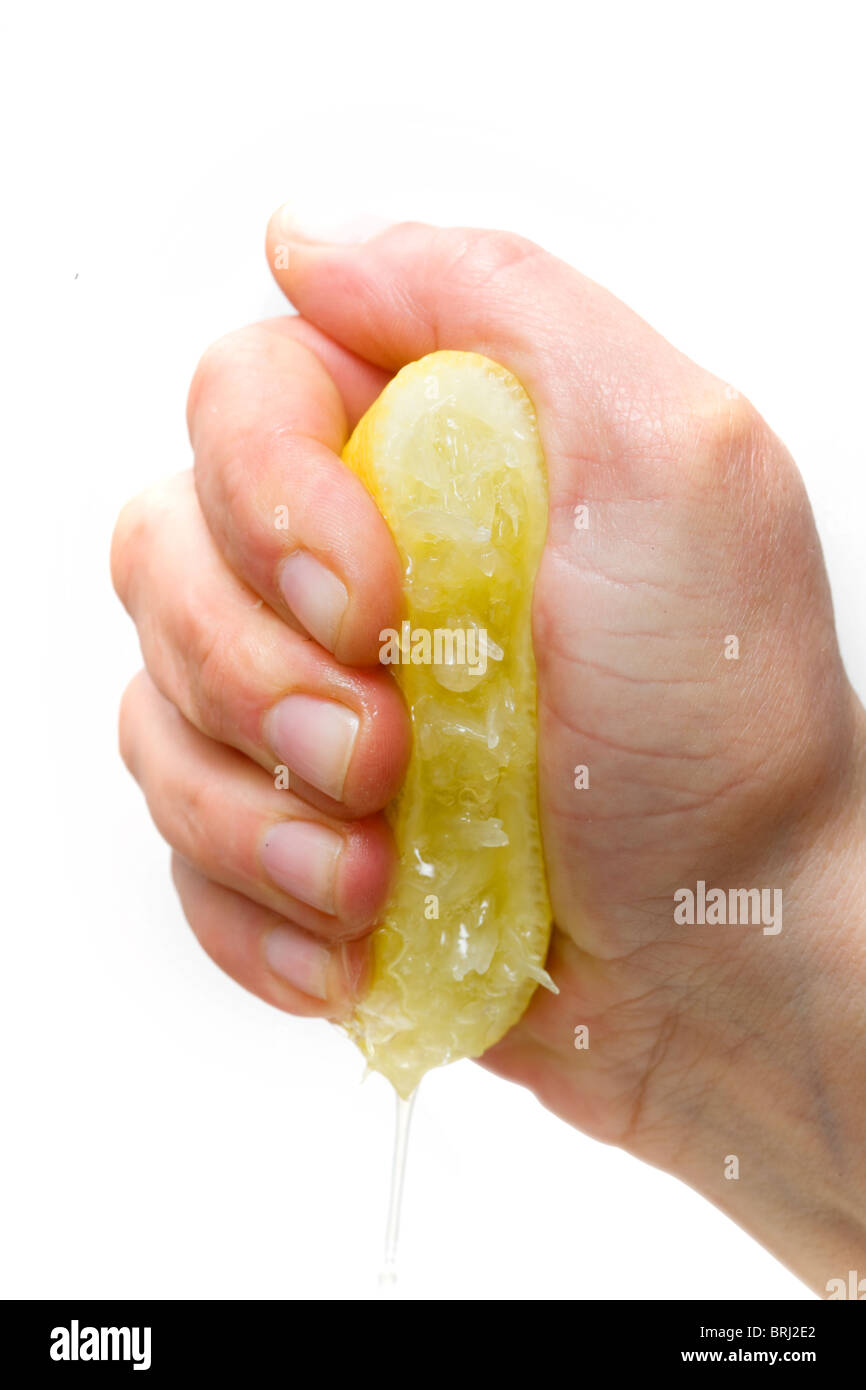 hand squeezing half lemon Stock Photo - Alamy
