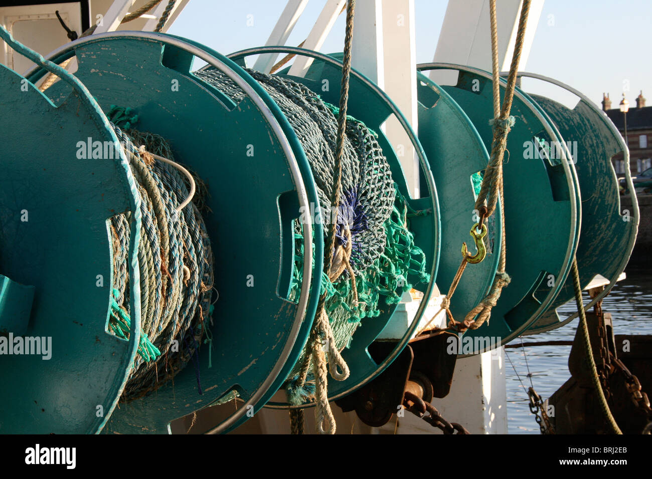 Fishing boat nets on winch drums Stock Photo - Alamy