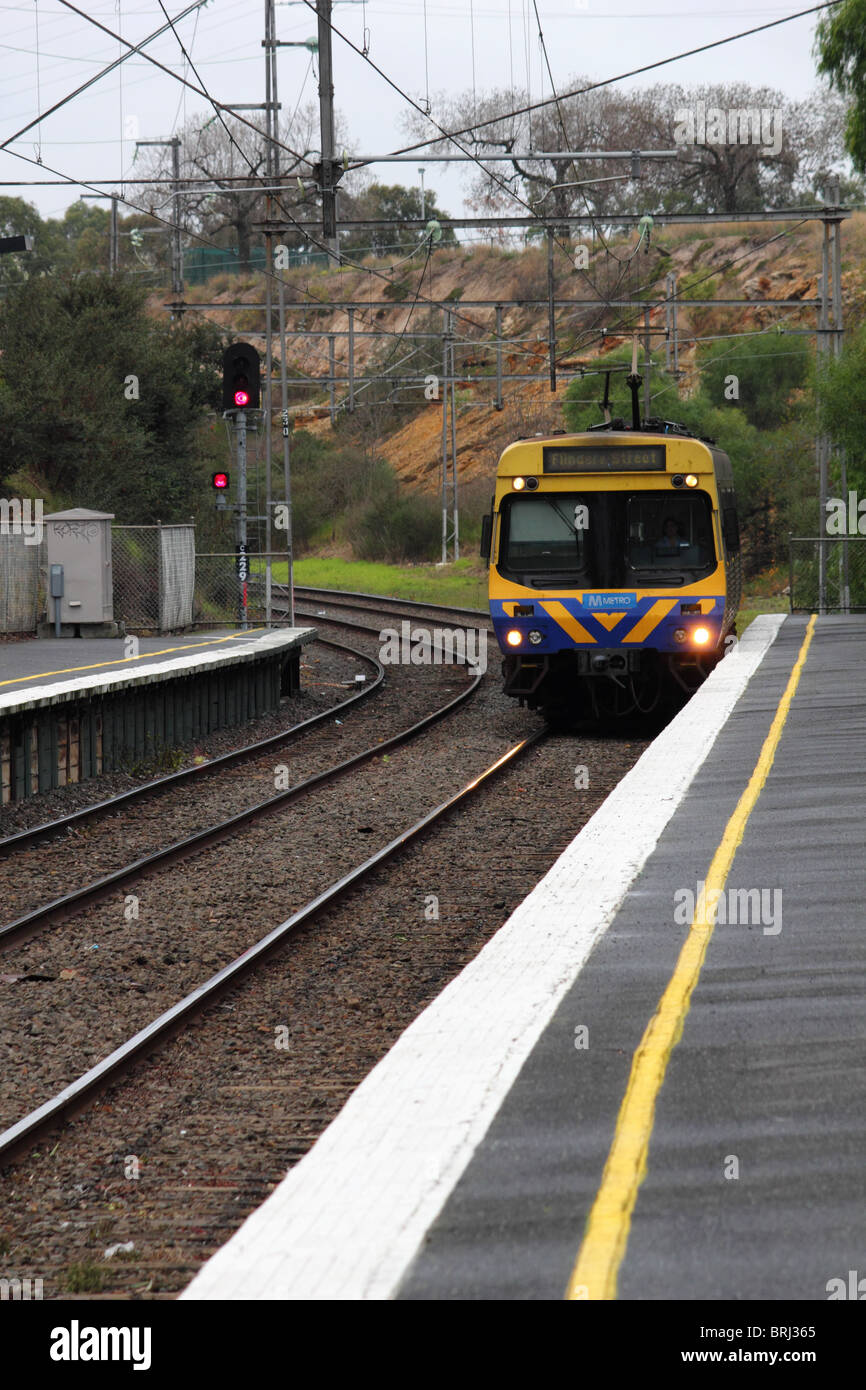 RAILWAY TRACKS WITH A TRAIN APPROACHING THE PLATFORM DESTINATION ...