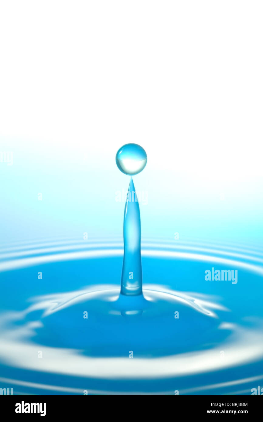 balance of nature - blue water drop macro on white. focus on suspended ...