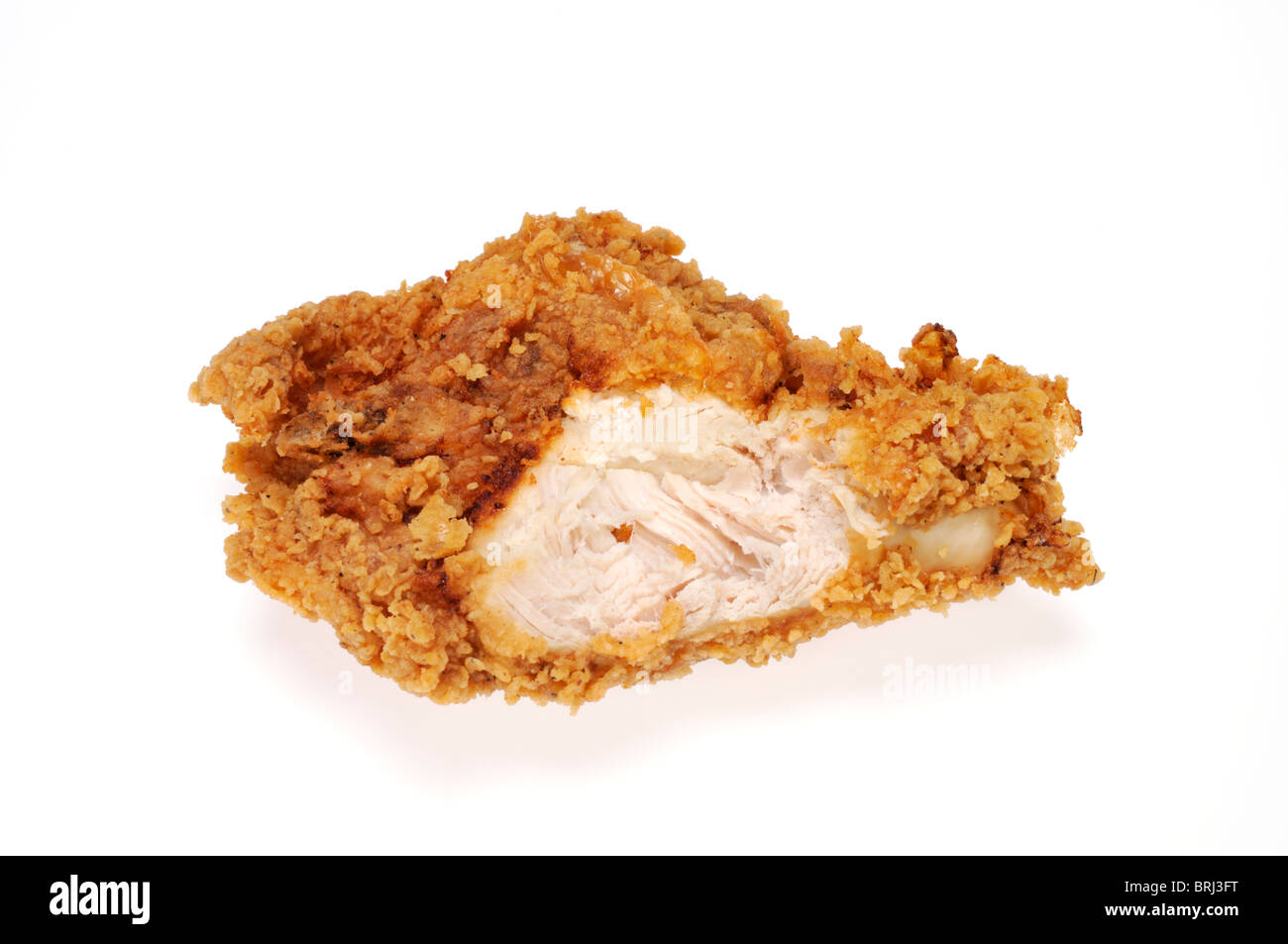 Cooked fried chicken breast with bite taken out of it on white ...