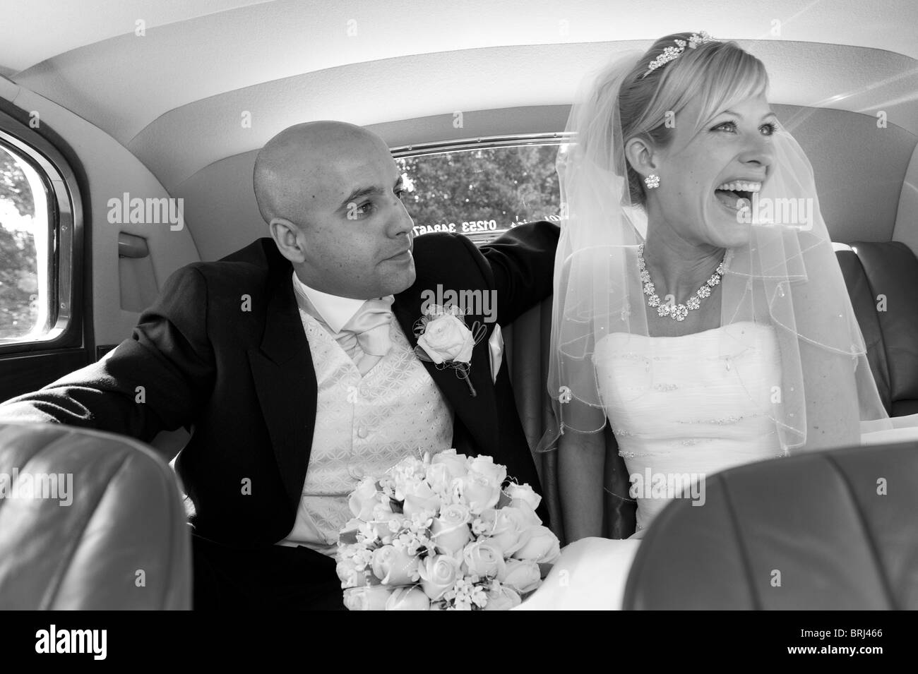 A very happy bride and groom as they arrive in their wedding car Stock ...