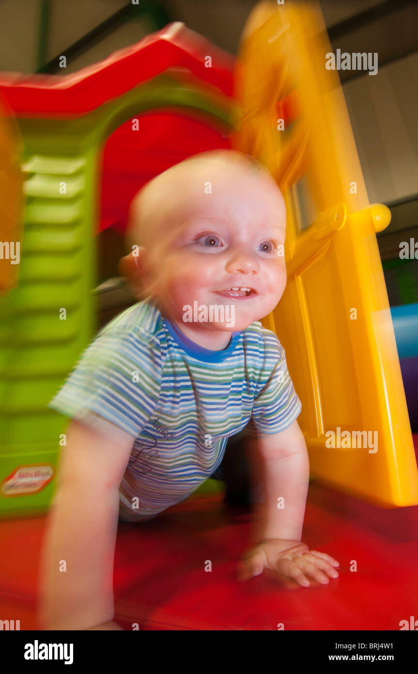 Baby crawling through play house door Stock Photo - Alamy