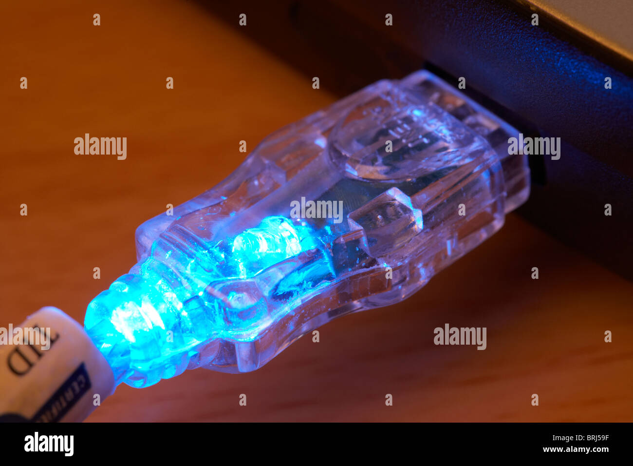 illuminated usb cable attached to a computer Stock Photo - Alamy