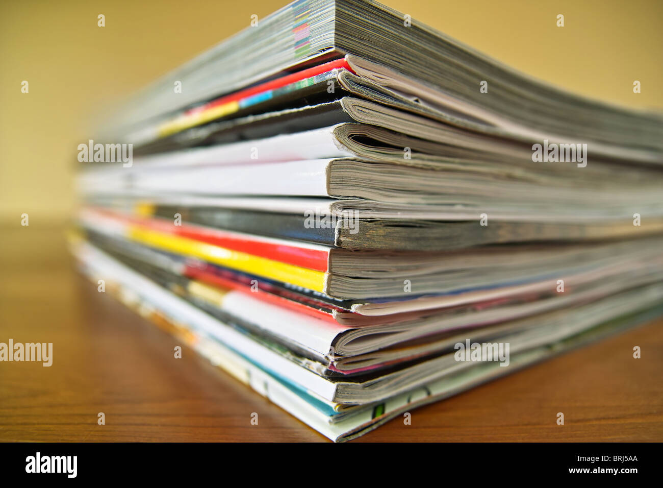 Magazines stacked on the table one on another Stock Photo - Alamy