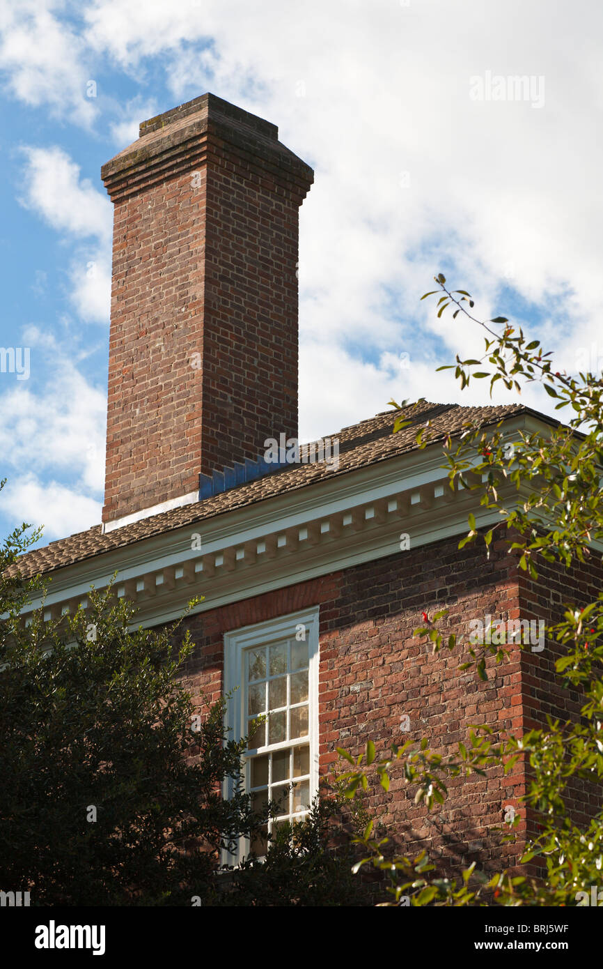 Brick residential building with large brick chimney in Colonial ...