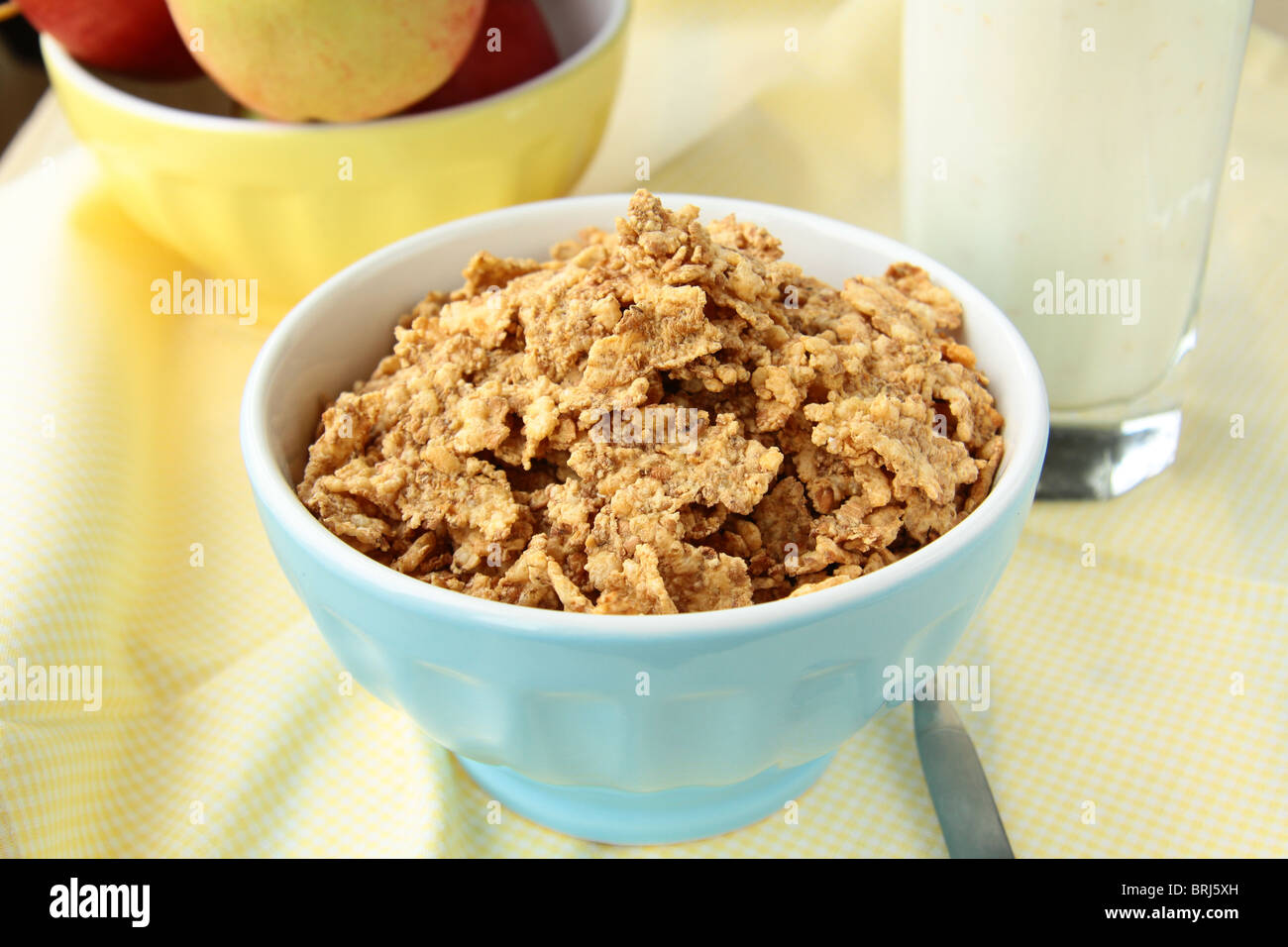 muesli breakfast in the blue cup and an apple with milk in the ...