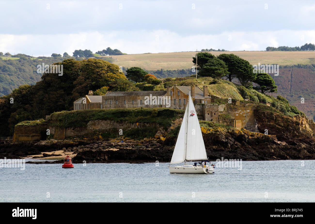 Sailing boat off Drake Island in Plymouth Sound south Devon England UK ...