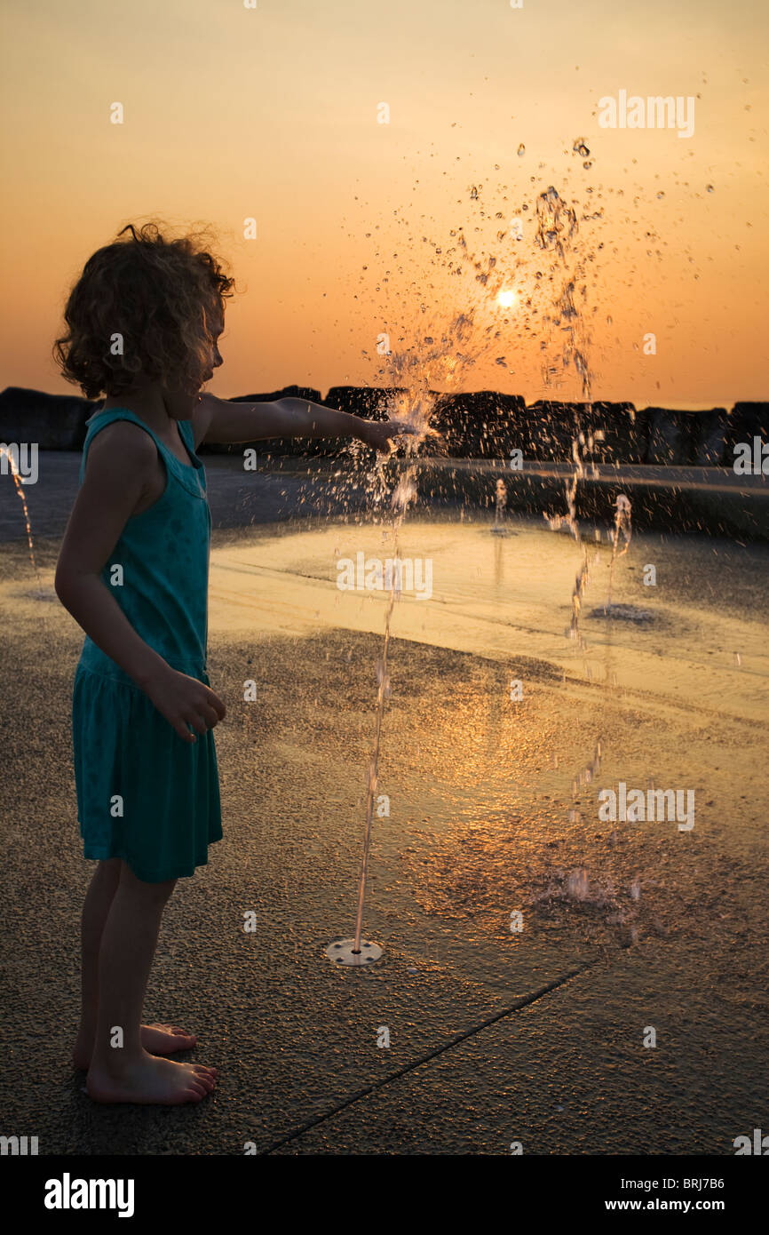Young girl playing with water jets on Morecambe West Promenade at ...