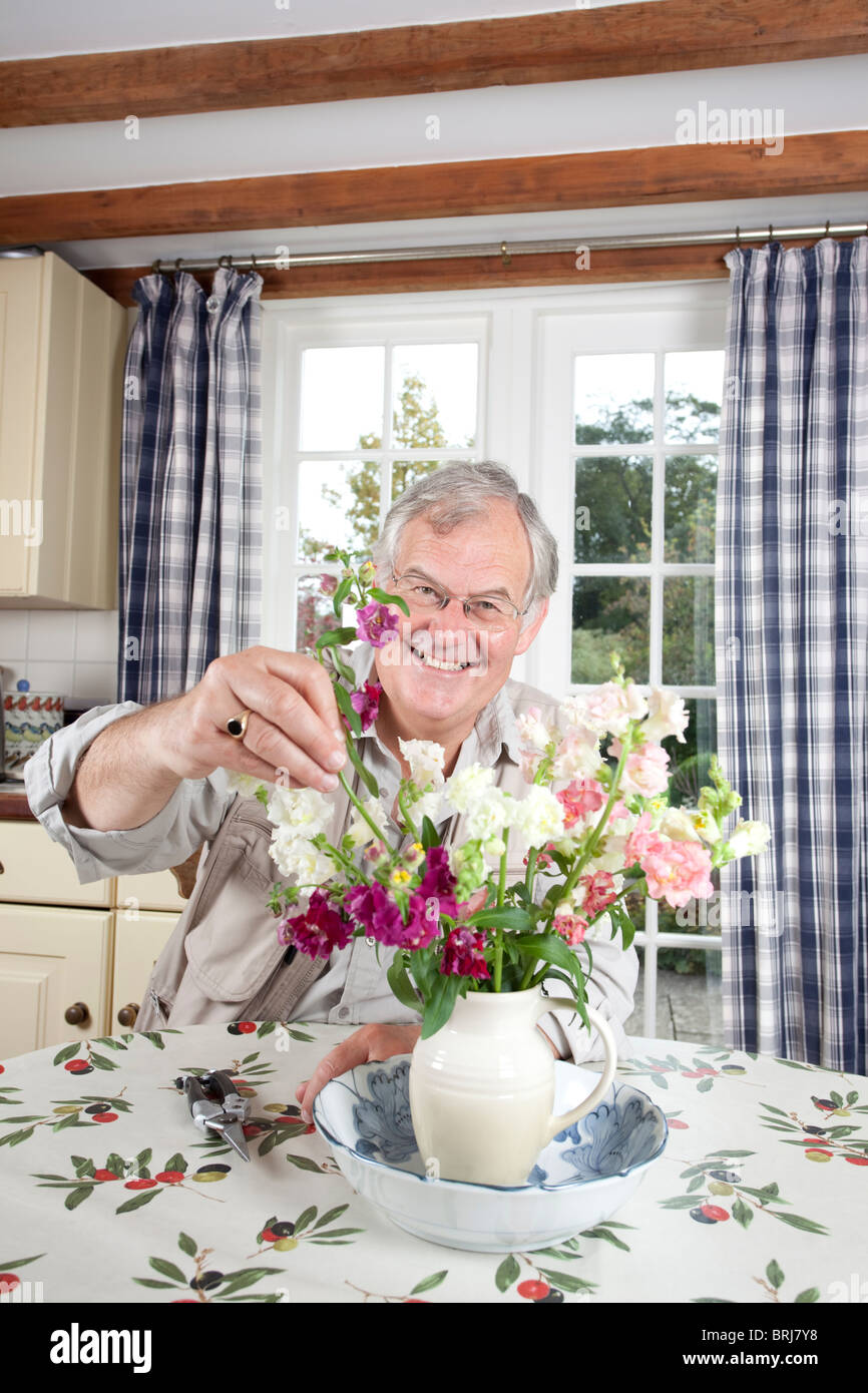 man flower arranging in cottage kitchen Stock Photo - Alamy