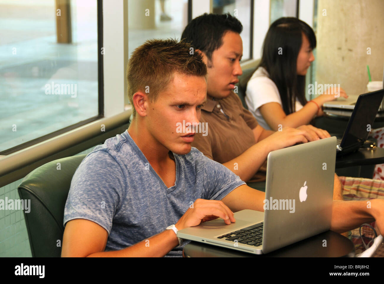 College students work on their laptops at the campus library Stock ...