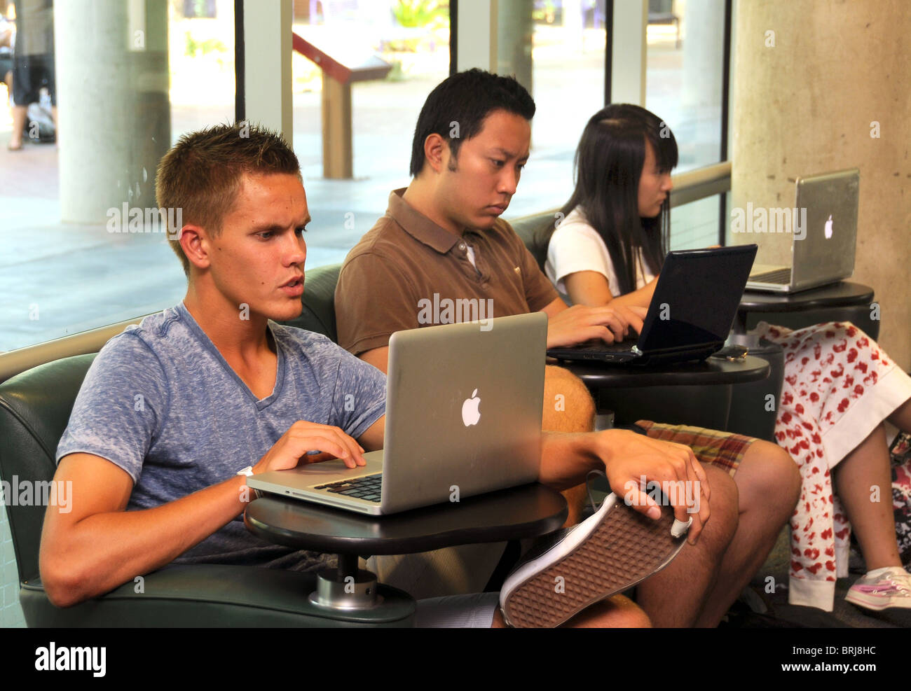 College students work on their laptops at the campus library Stock ...