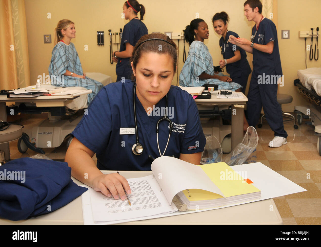 Nursing students conduct physical assessments on each other as part of ...