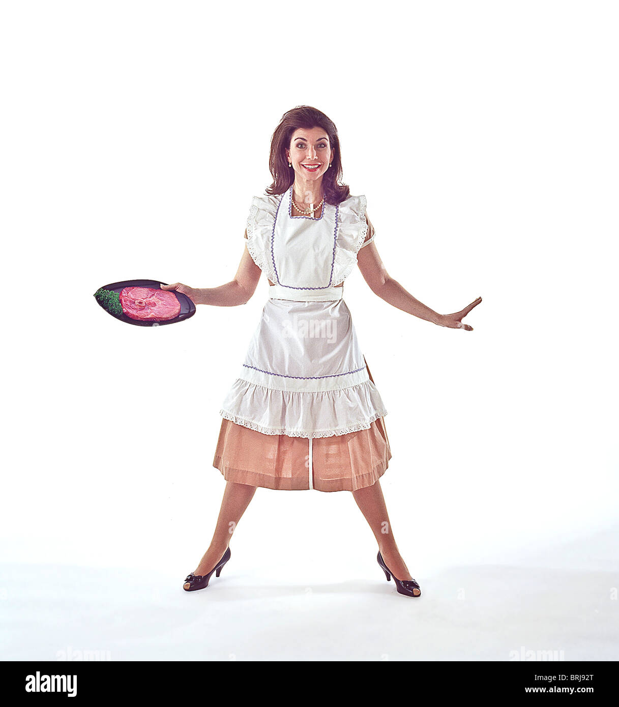 Femalw caucasian housewife shows exuberance. Dinner platter. Retro ...