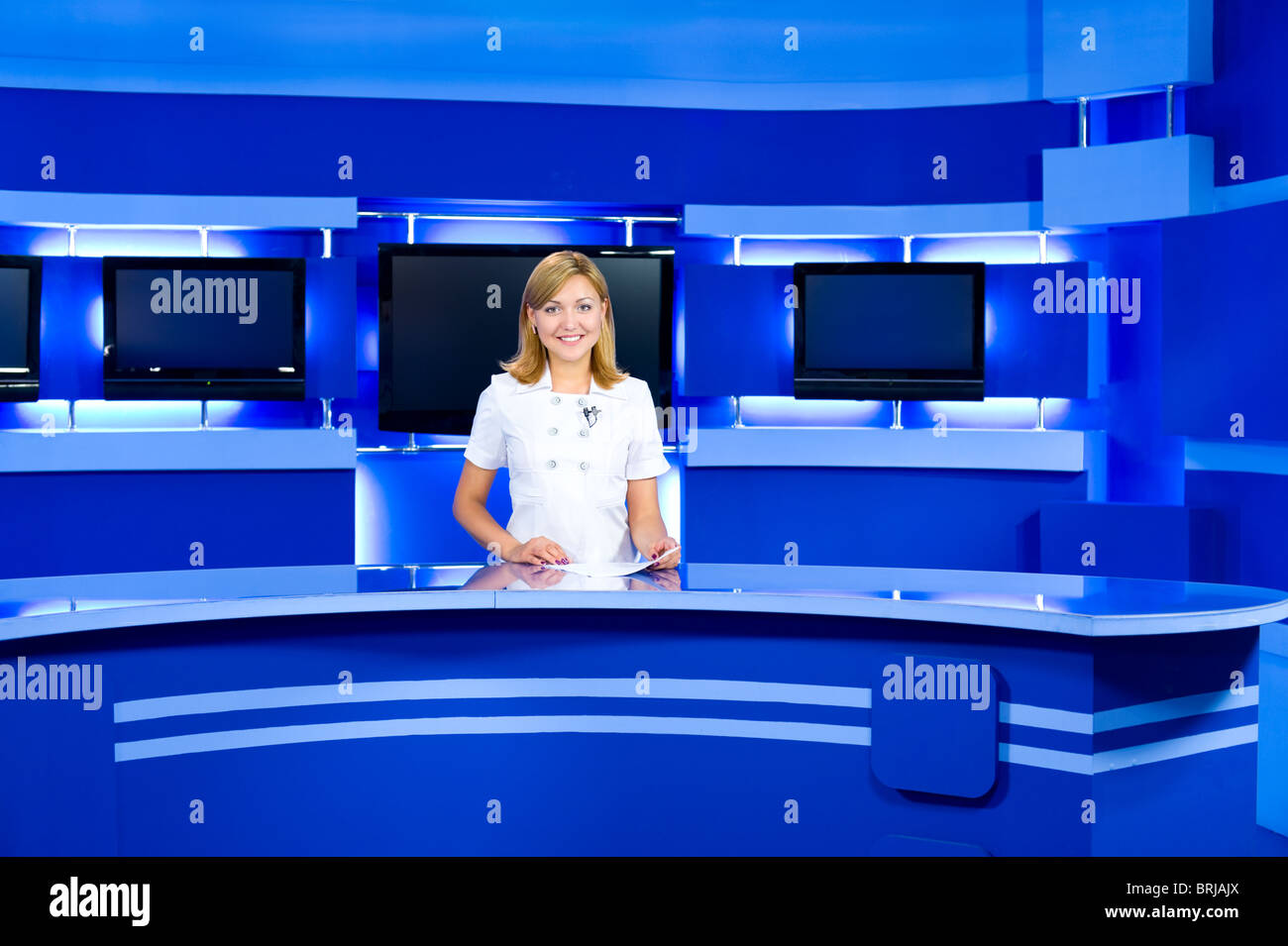 a television anchorwoman at studio during live broadcasting Stock Photo ...