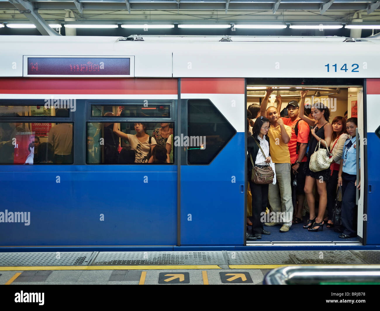 Bangkok skytrain doors open and passengers aboard. Thailand S. E. Asia ...