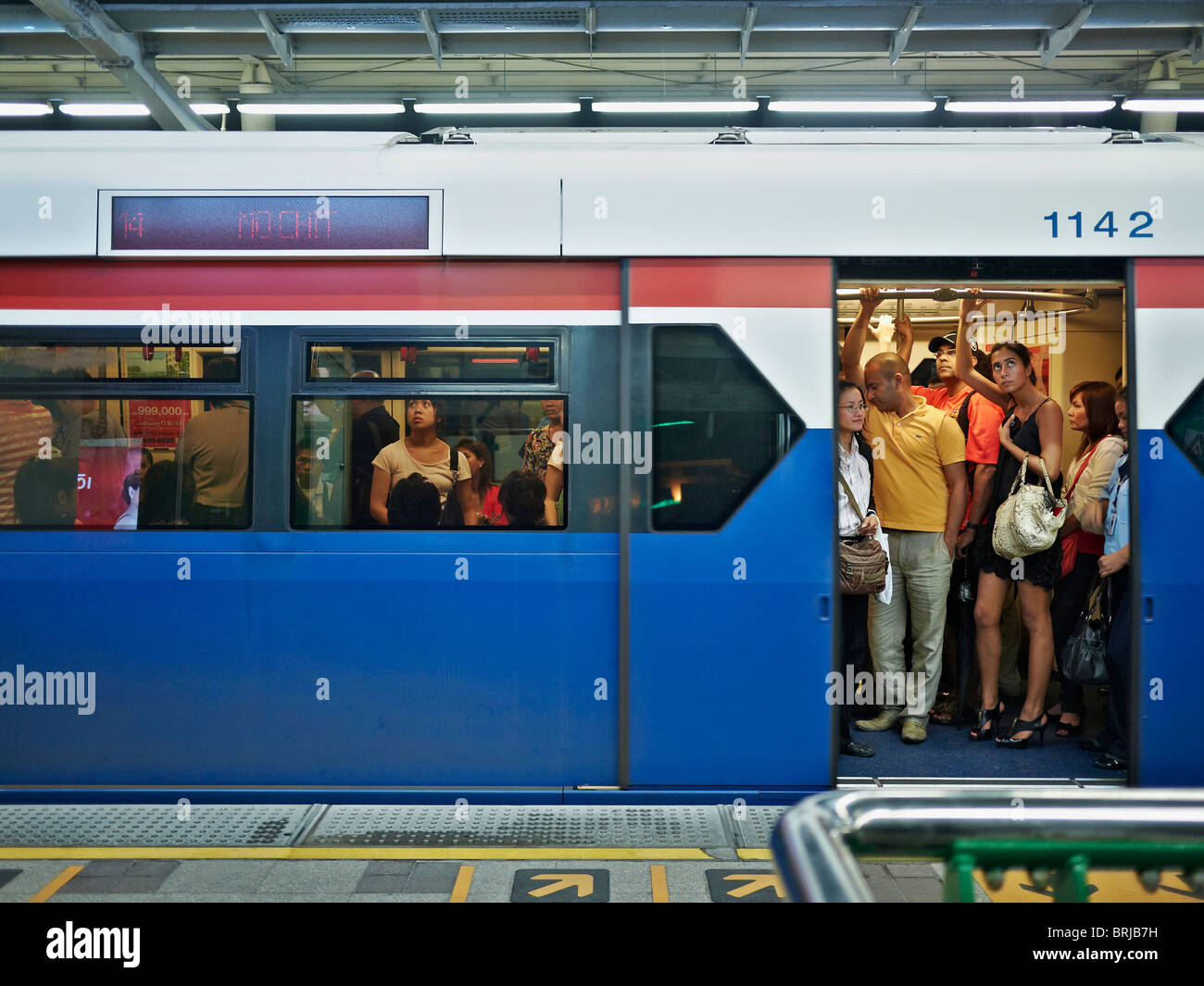 Bangkok skytrain doors open and passengers aboard. Thailand S. E. Asia ...