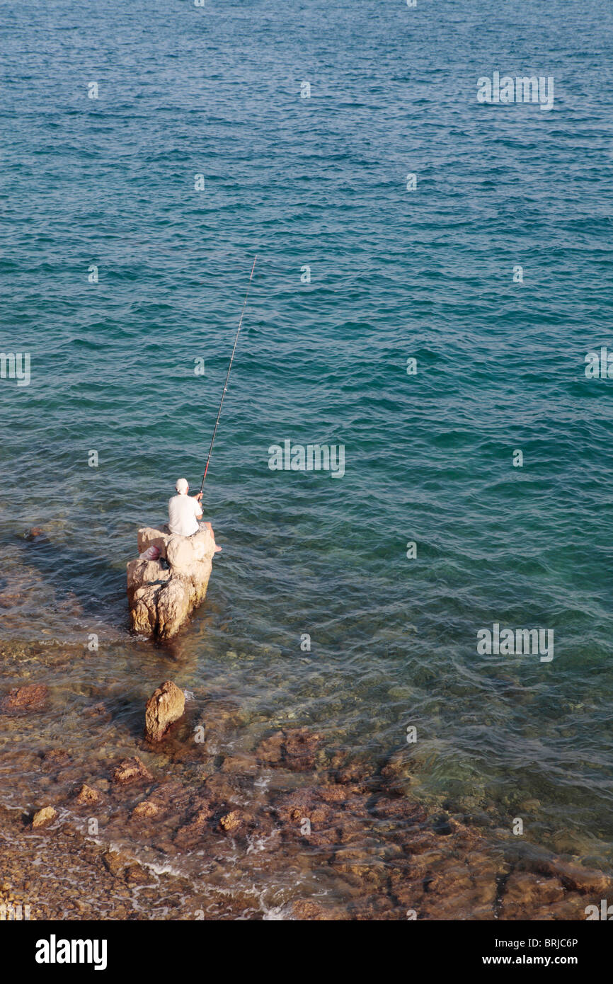 Man sea fishing from rocks hi-res stock photography and images - Alamy