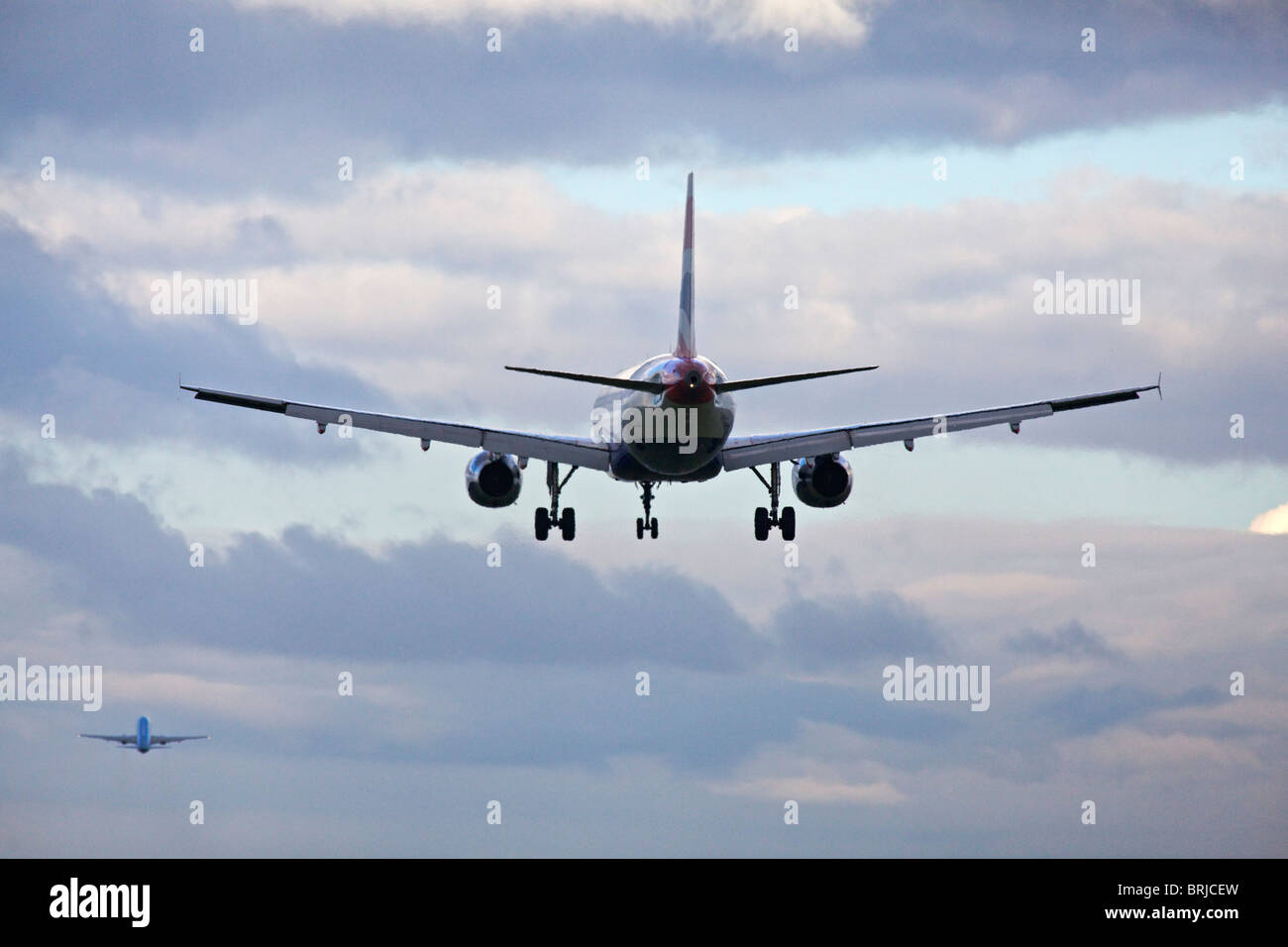 A plane landing and one taking off at Edinburgh airport, Scotland, UK ...