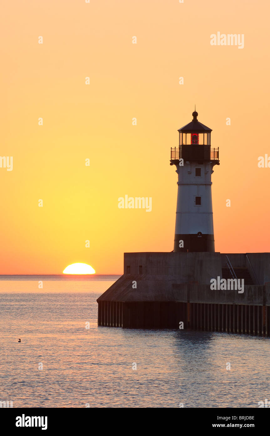 Sunrise at the north breakwater lighthouse at the entry to Duluth ...