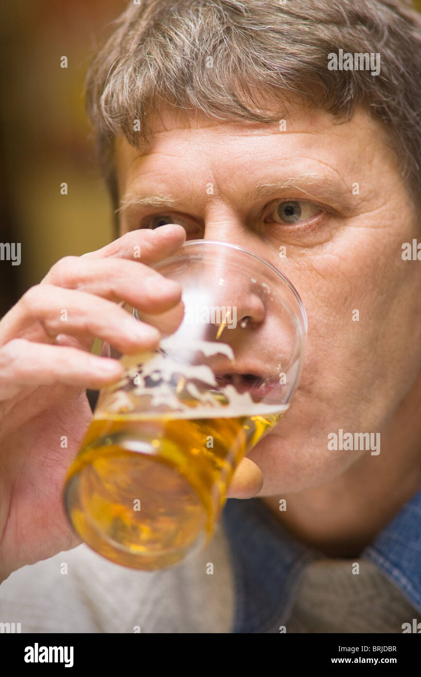 Mature man drinking beer Stock Photo - Alamy