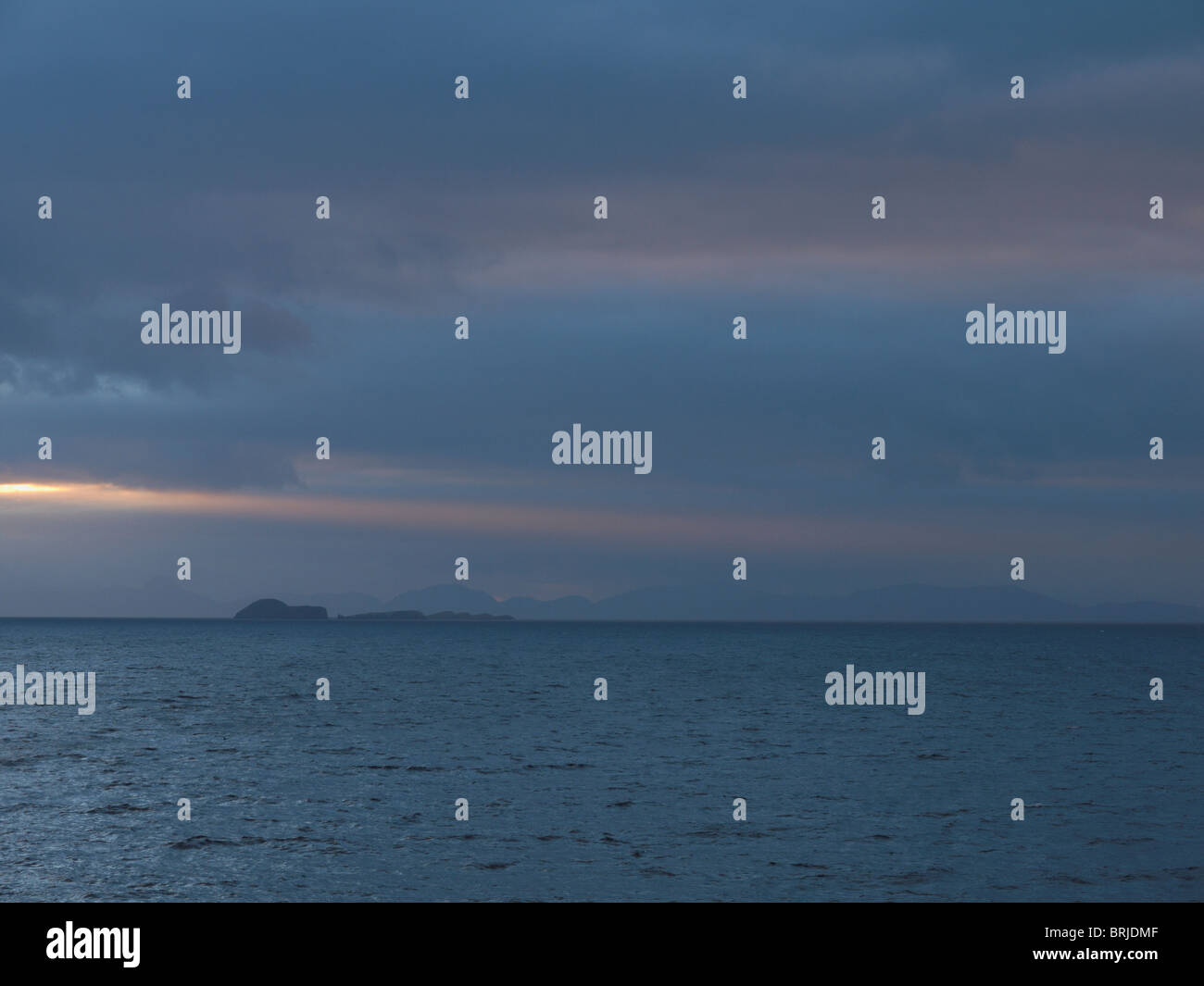 Light shafts at sunset over the Outer Hebrides from the Isle of Skye ...