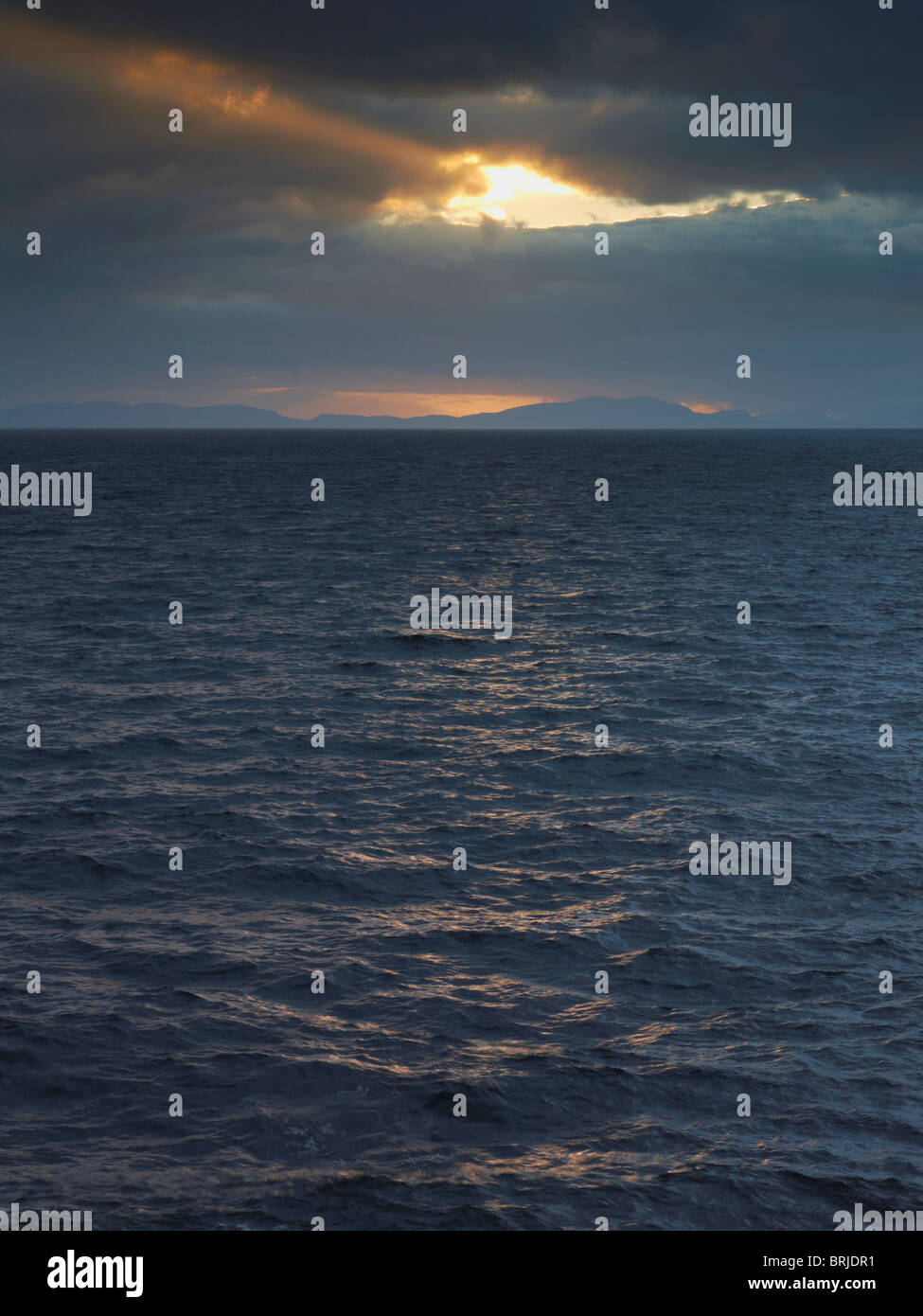 Light shafts at sunset over the Outer Hebrides from the Isle of Skye ...