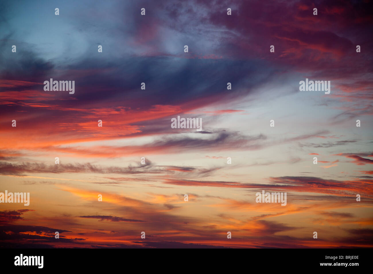 Firey red and orange clouds in a Mediterranean sunset Stock Photo - Alamy
