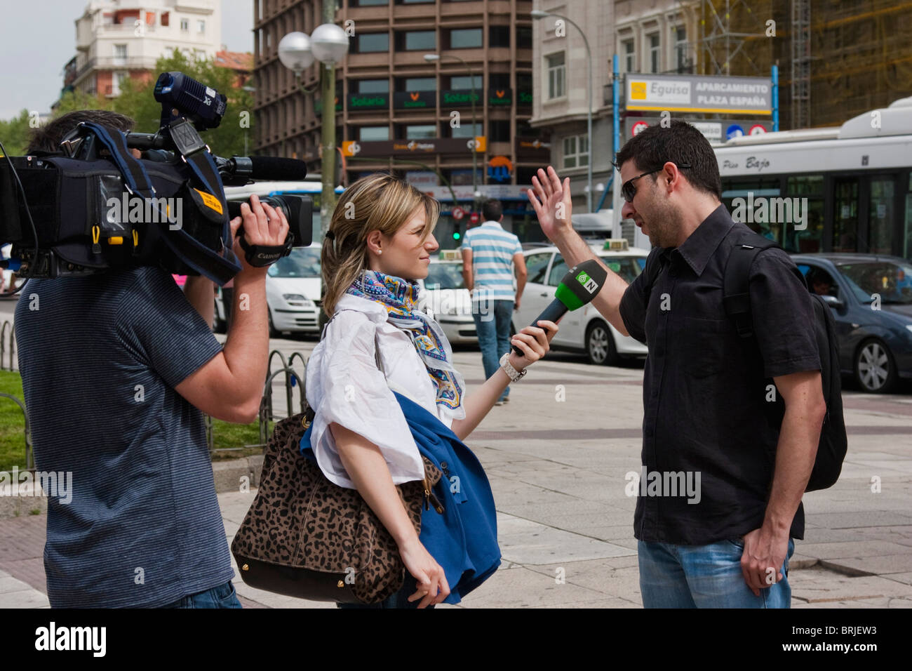 Man being interviewed by female reporter and tv crew in Madrid Stock ...
