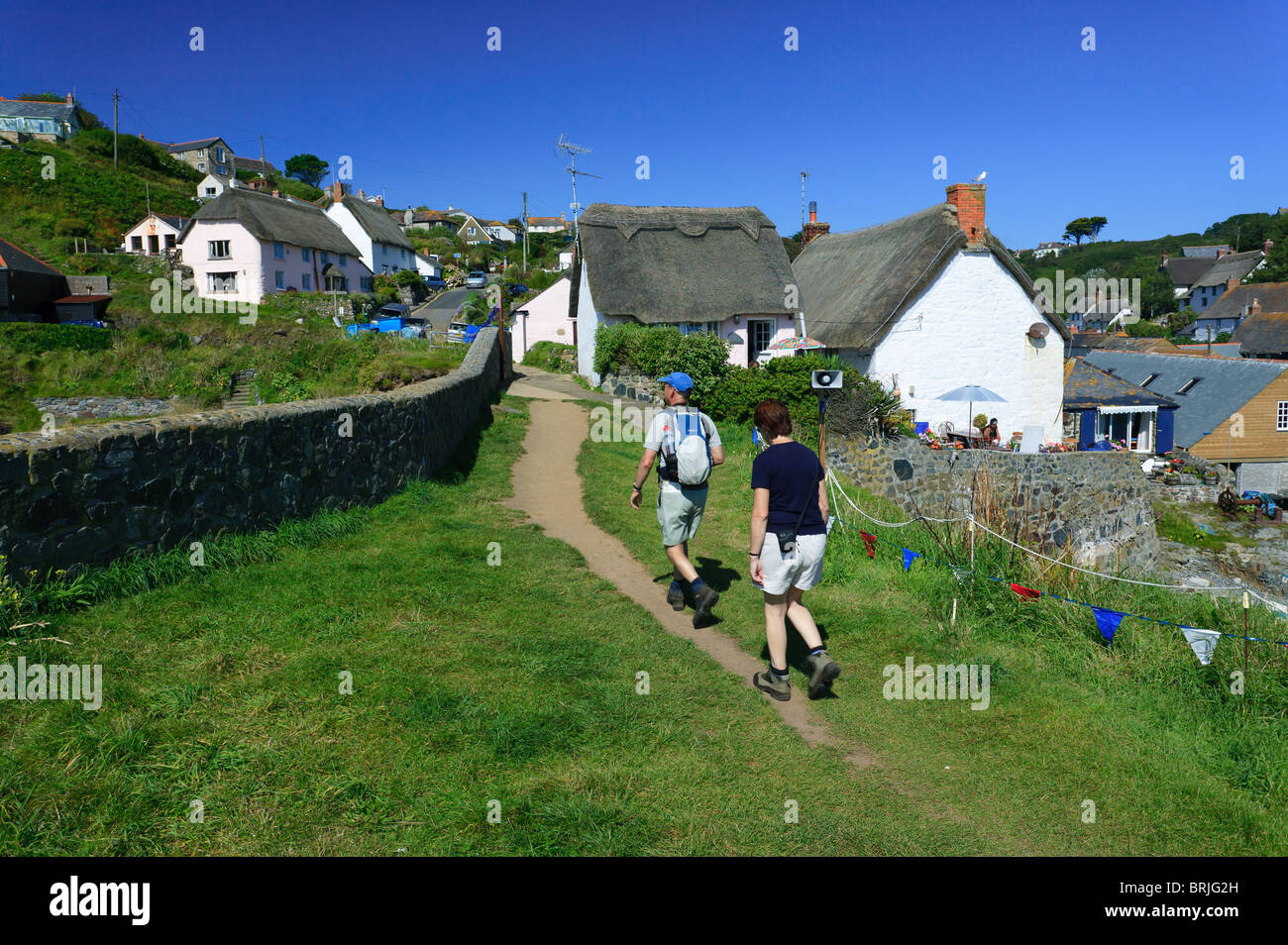 Ramblers in Cadgwith Cove, Cornwall, England Stock Photo - Alamy