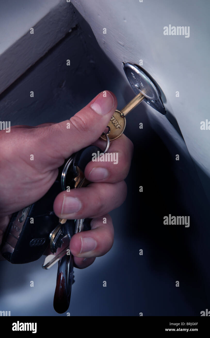 Male hand locking or unlocking a door Stock Photo - Alamy