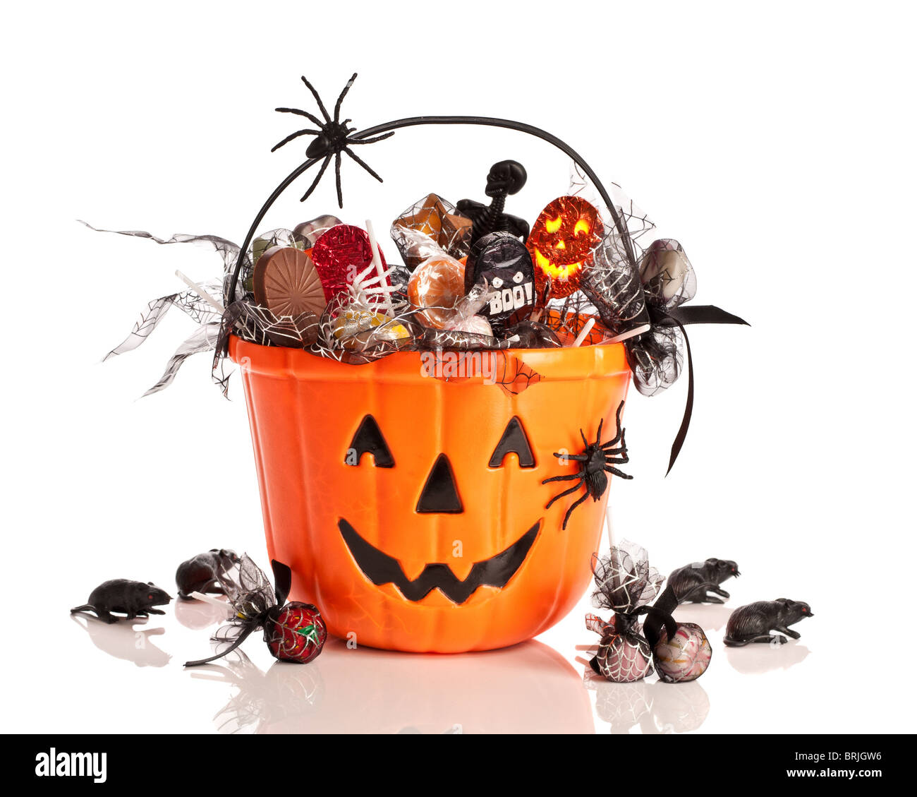 Trick or treat halloween bucket filled with candies and spiders on ...