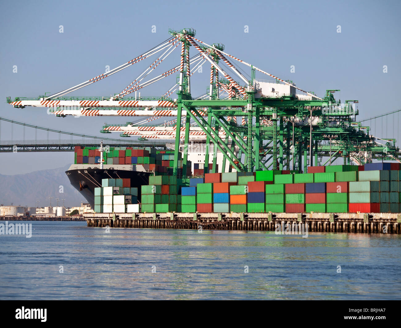 Containers, cranes, bridge and ship in warm late afternoon light Stock ...