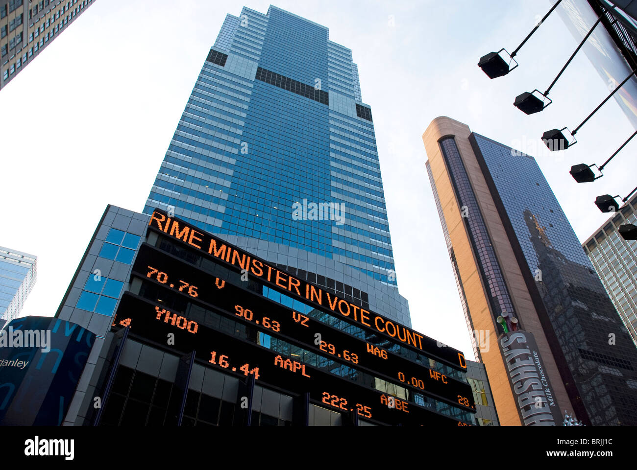Continuous scrolling stock exchange quotes in front of NASDAQ building ...