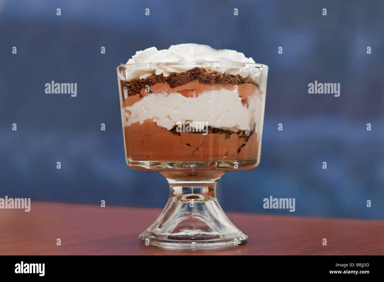 one solo low fat chocolate mousse with whipped topping sitting in a ...